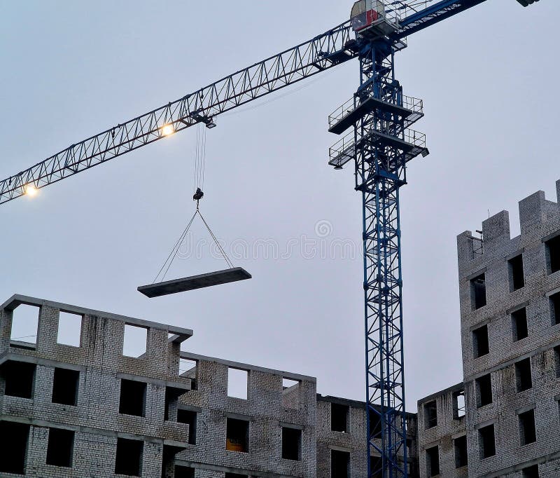 Crane at a Construction Site Lifts a Concrete Slab. Stock Image - Image ...