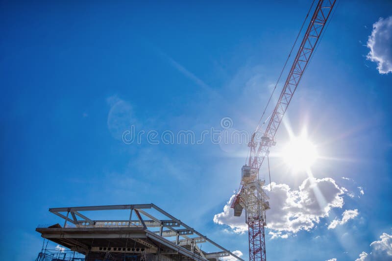 Crane on a Construction Site, Modern Building, Sun Backlit, Wide ...