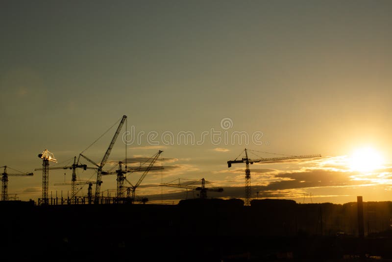 Crane and Construction Site Sunset. Building Development and ...