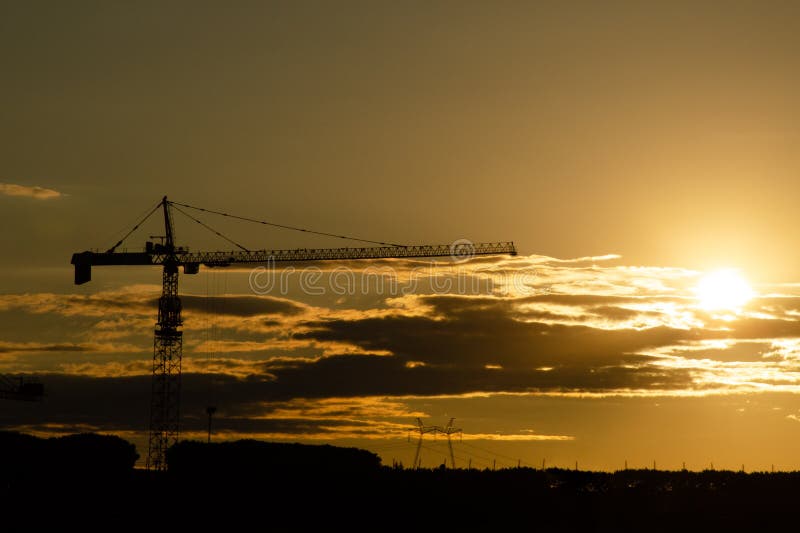 Crane and Construction Site Sunset. Building Development and ...