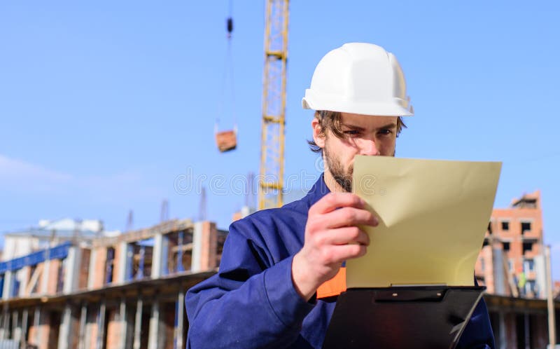 Control Construction Process. Builder in Working Clothes and Helmet ...