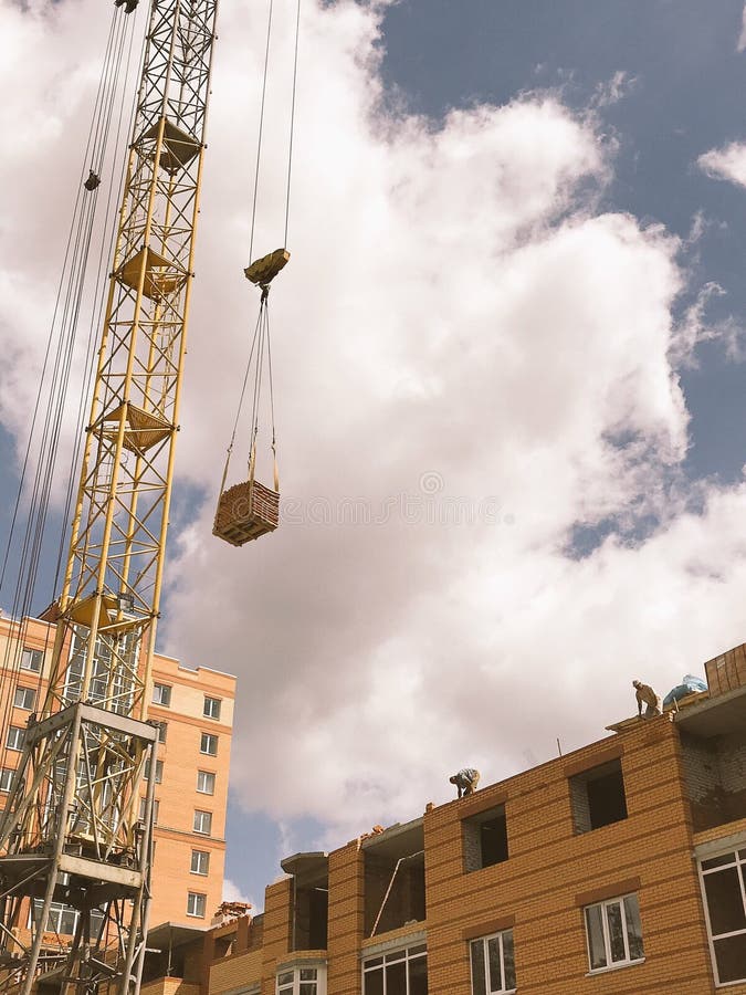 A Crane Delivers a Load of Bricks To an Apartment Stock Image - Image ...