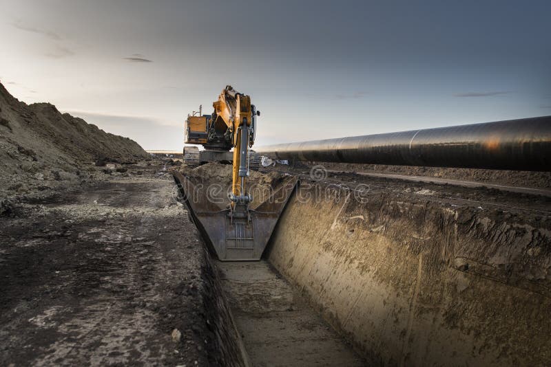 Crane Digging a Channel for Gas Pipeline Stock Photo - Image of evening ...