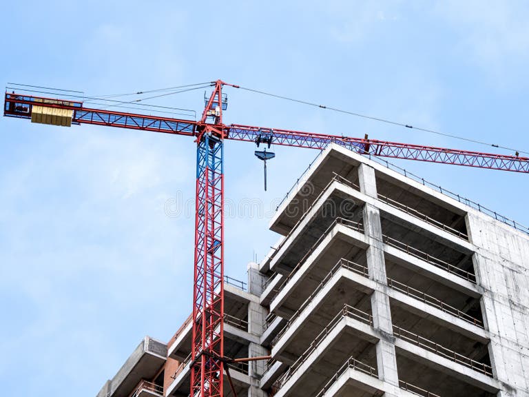 A Crane in Front of a Building Under Construction Stock Photo - Image ...