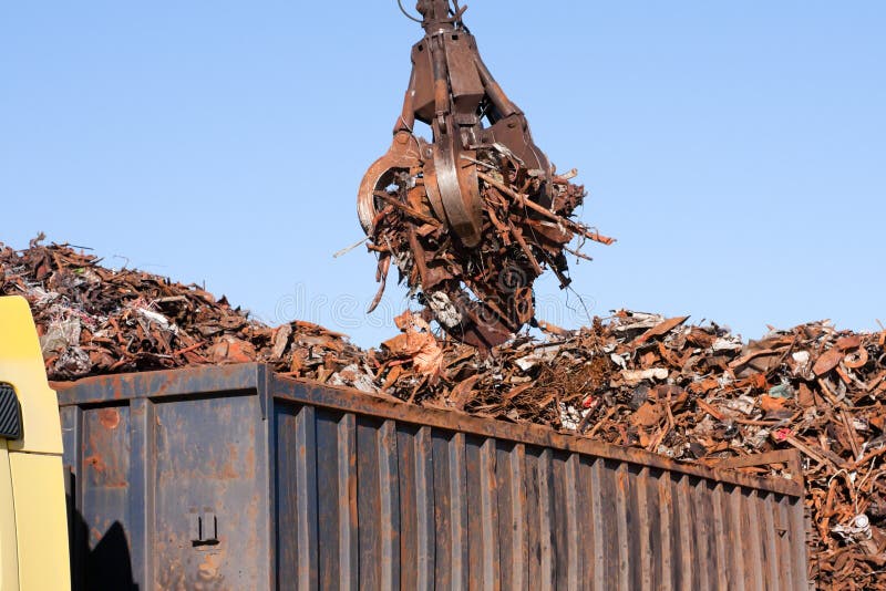 Crane Grabber Loading a Truck with Metal Scrap Stock Photo - Image of ...