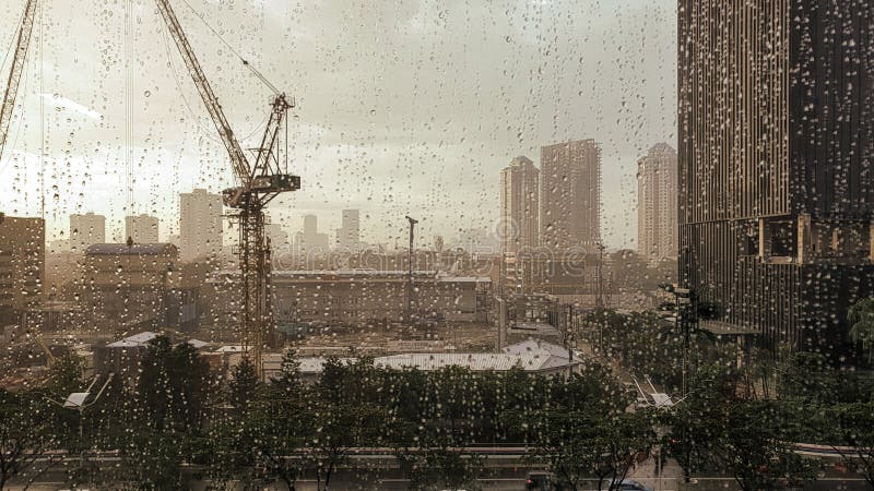 A Crane in Heavy Rain is Working on Building a Skyscraper Stock Image ...
