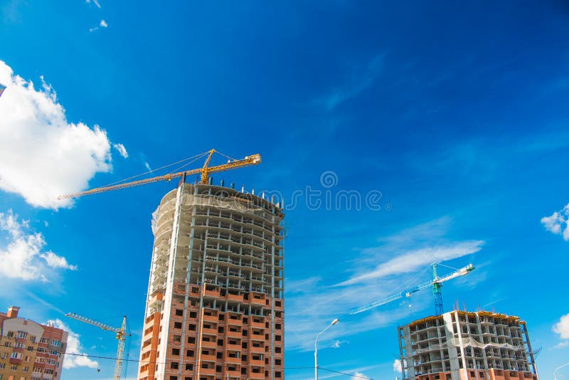 Crane and High-rise Building Under Construction Works Against Sun Blue ...