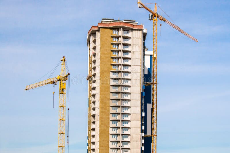 Crane and High-rise Building Under Construction Works Against Sun Blue ...