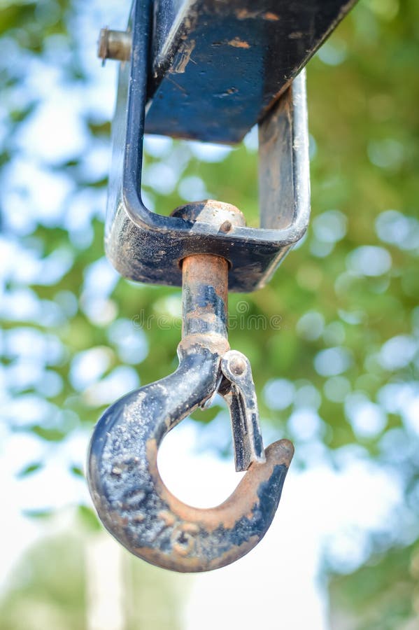 Crane Hook Hanging Over Blue Sky and Green Tree in Outdoors Background ...
