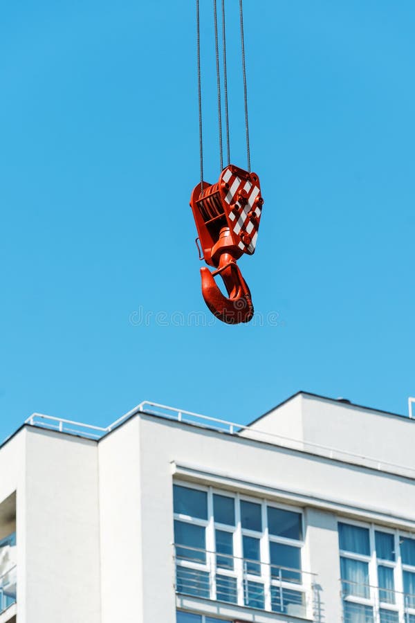 A Crane Hook Hangs Over the Constructed Building. Vertical Photo Stock ...