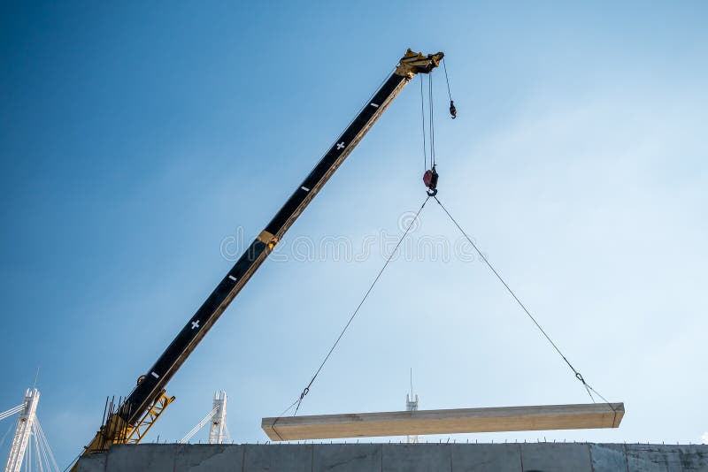 Crane lifting cement block stock photo. Image of architecture - 35906582