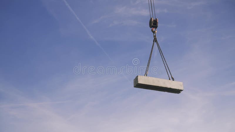 Crane Lifting Concrete Block Against Blue Sky Stock Video - Video of ...