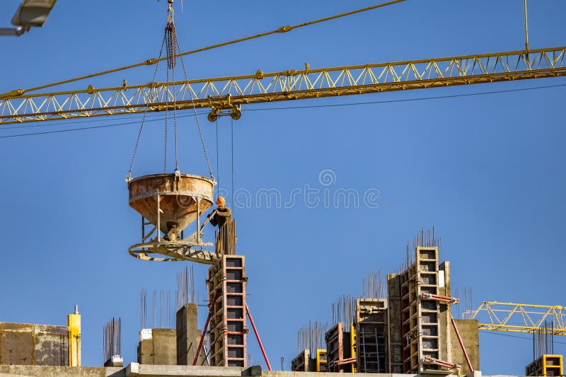 Crane Lifting Concrete Container on Construction Site. Construction of ...