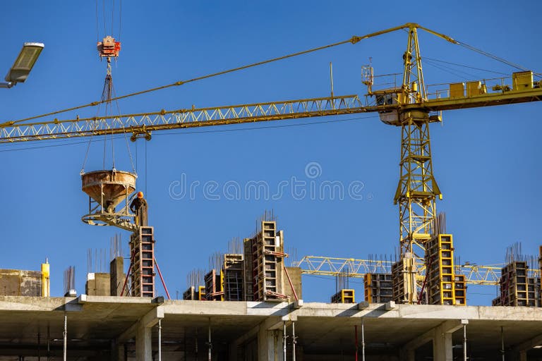 Crane Lifting Cone Tank for Concrete on Construction Site. Tank with ...