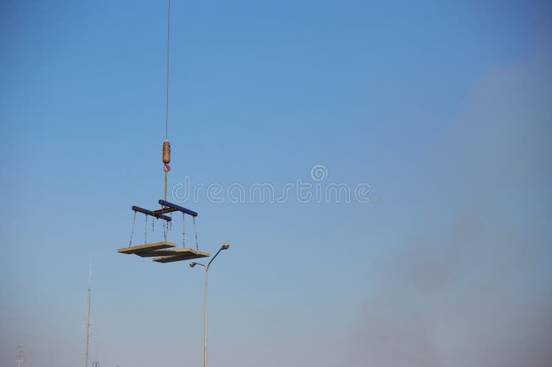 Crane Lifting Heavy Load Material on a Construction Site Stock Photo ...