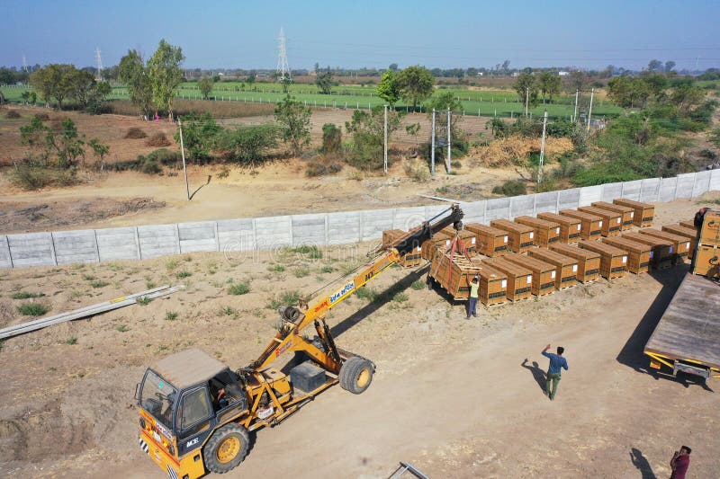 Large Crane in the Center of a Stadium Field, with Construction Workers ...