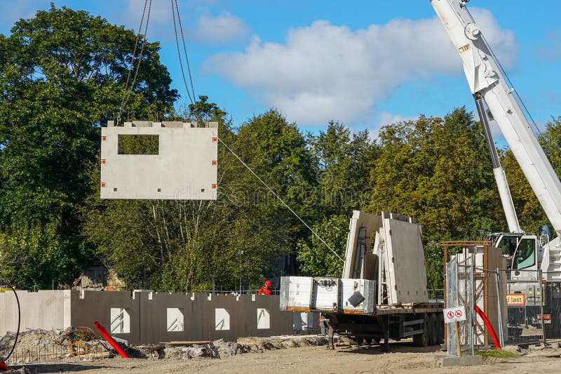 Crane Lifting Precast Concrete Wall Panel at Multi-story Residential ...
