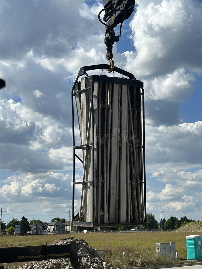 A Crane Lifts a Crate of Precast Concrete Panels Stock Photo - Image of ...