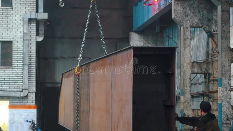 A Crane Lifts the Iron Part of the Structure at a Construction Site ...