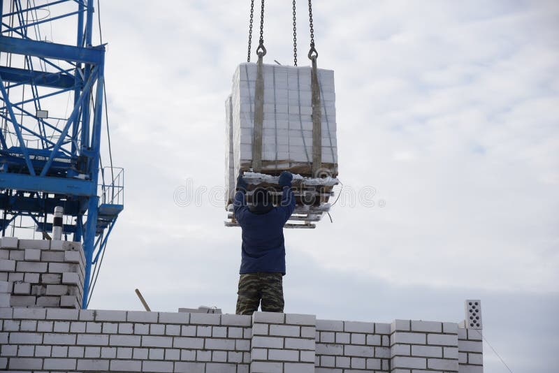A Crane Lifts the Pallet with Bricks. Stock Image - Image of house ...