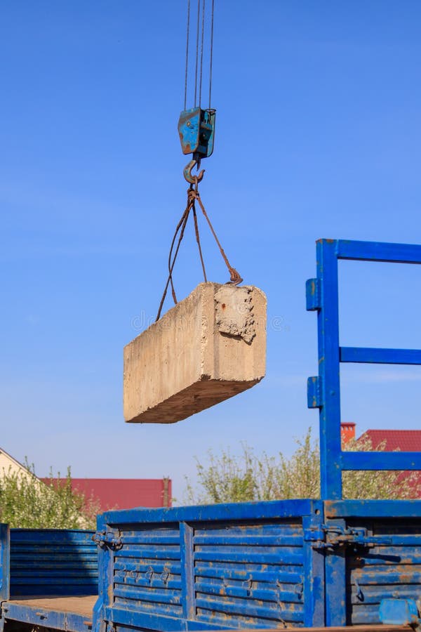 The Crane Loads Old Concrete Blocks at the Construction Site Stock ...