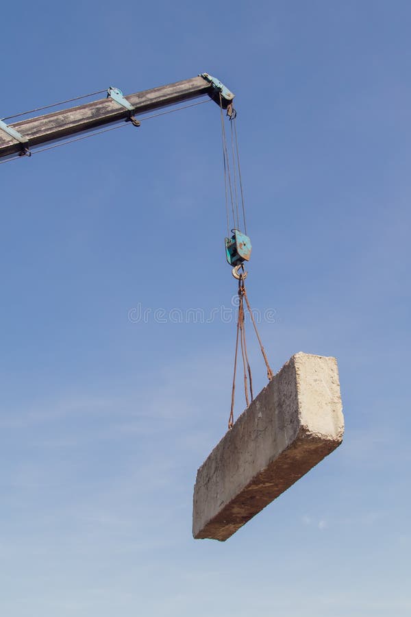 The Crane Loads Old Concrete Blocks at the Construction Site Stock ...