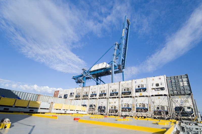Crane Lowering Container To Stack of Containers. Stock Image - Image of ...