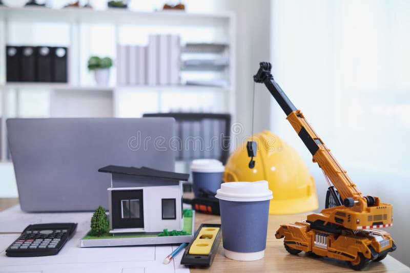 Crane Model Sits on Table of Construction Engineer after Discussing How ...