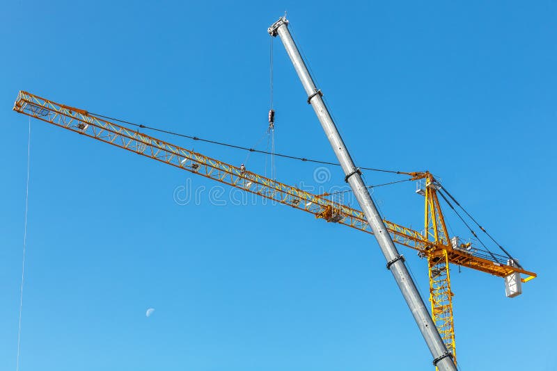 Crane montage in sunny day stock photo. Image of construction - 204843582