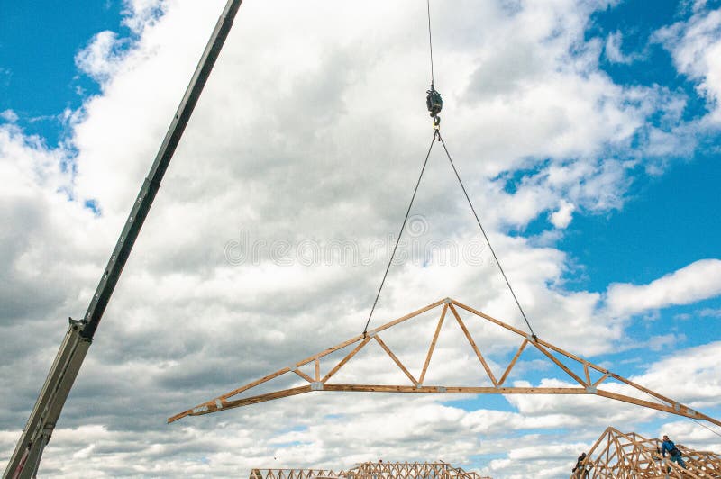 Crane Moving Roof Trusses, into Place Stock Photo - Image of blue ...