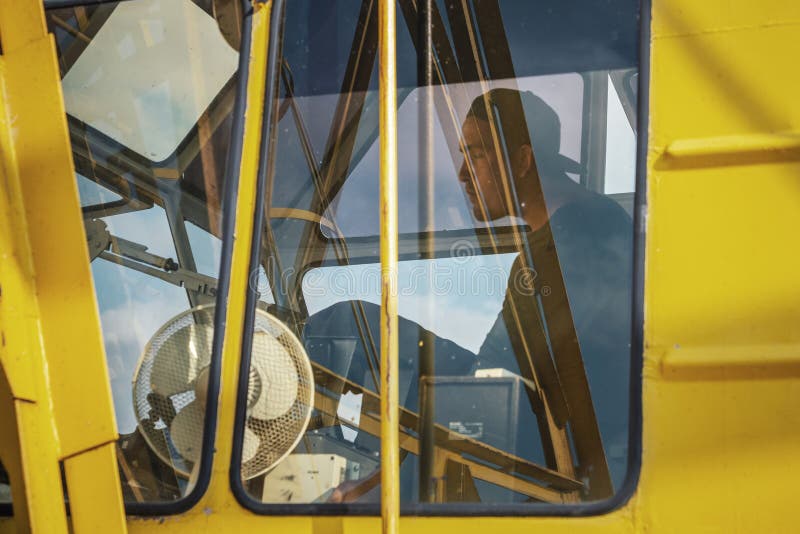 Crane Operator Controls Heavy Machinery at a Loading Dock by the River ...