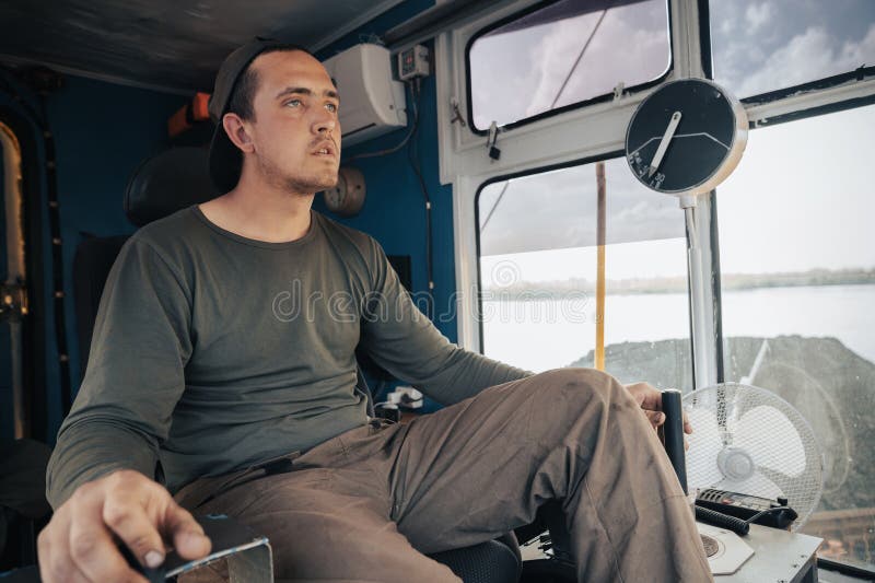 Crane Operator Controls the Joystick of the Crane, Front Side View ...