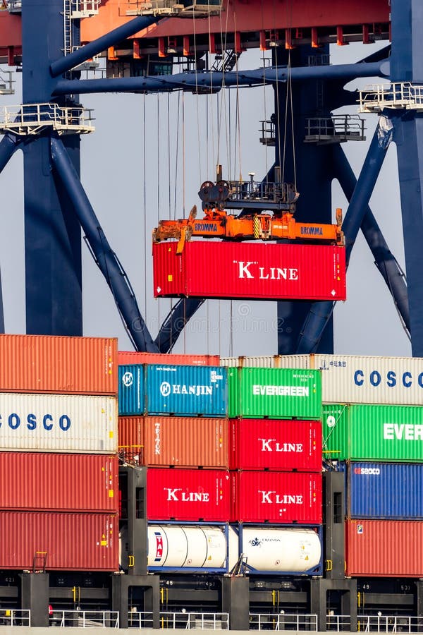 Crane Operator Unloading a Sea Container from a Cargo Ship in the Port ...