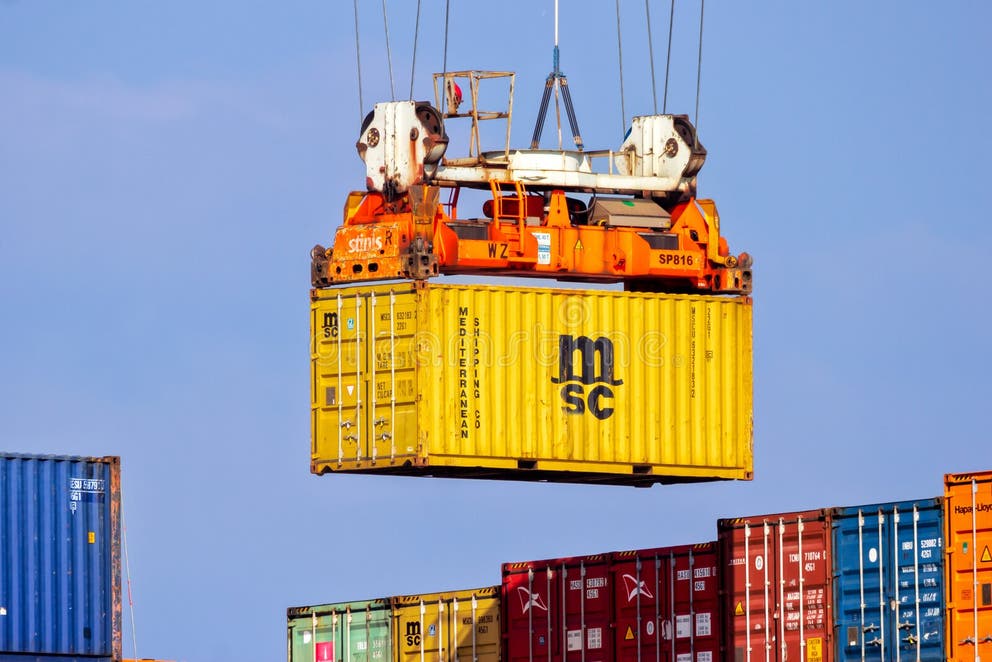 Crane Operator Unloading a Sea Container from a Cargo Ship in the Port ...
