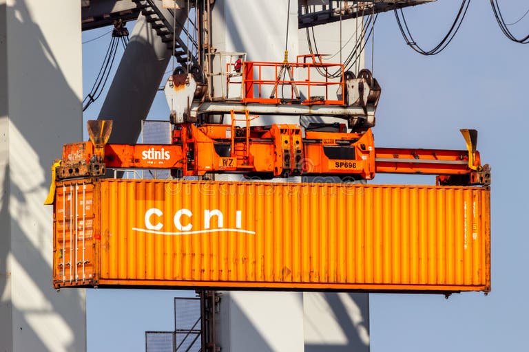 Crane Operator Unloading a Sea Container from a Cargo Ship in the Port ...