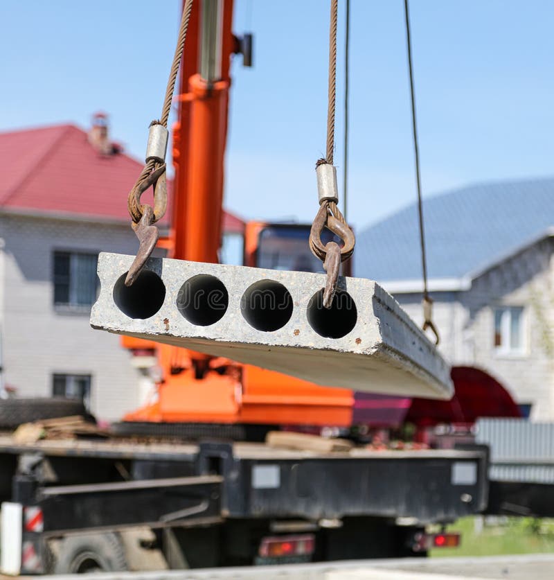 A Crane Raised a Concrete Slab at a Construction Site at Home Stock ...