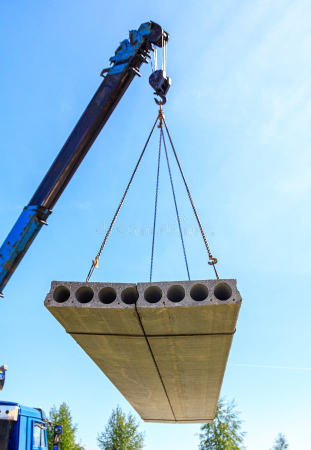 A Crane Raised a Concrete Slab at a Construction Site at Home Stock ...