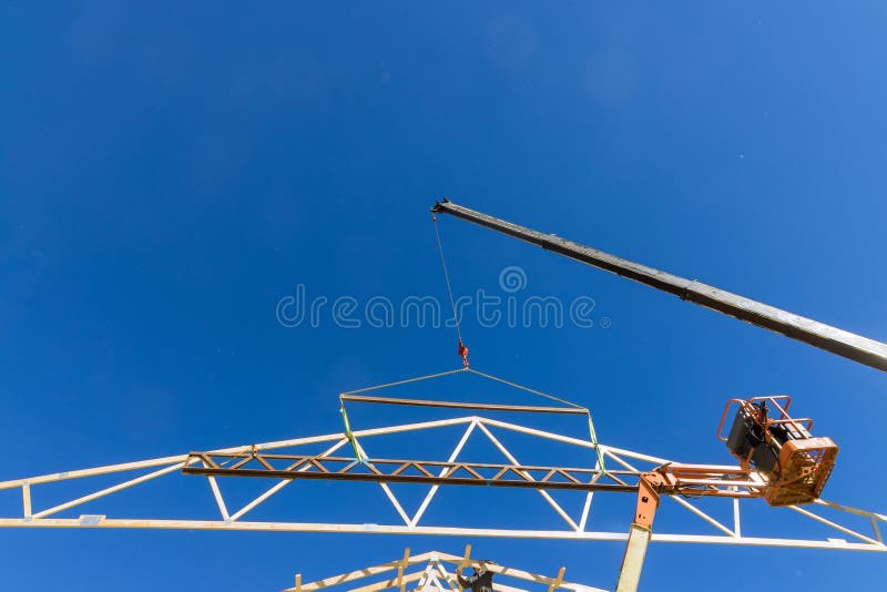 Crane Lifting Trusses Framework Component Against Clear Blue Sky during ...