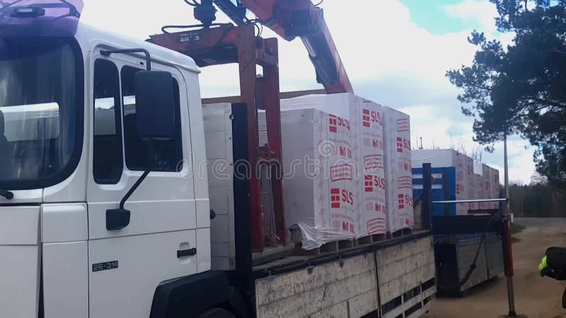Crane Lifts Cargo from Truck at Warehouse Loading Dock during Midday ...