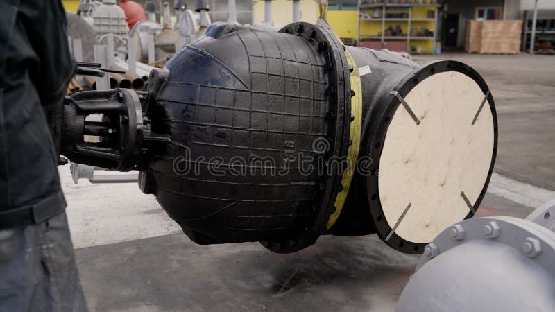 Crane Skillfully Lifting a Large Water Valve for Precise Installation ...