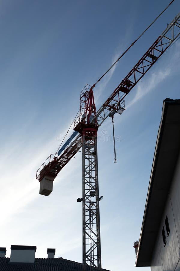 A Crane is in the Sky Above a Row of Buildings Stock Image - Image of ...