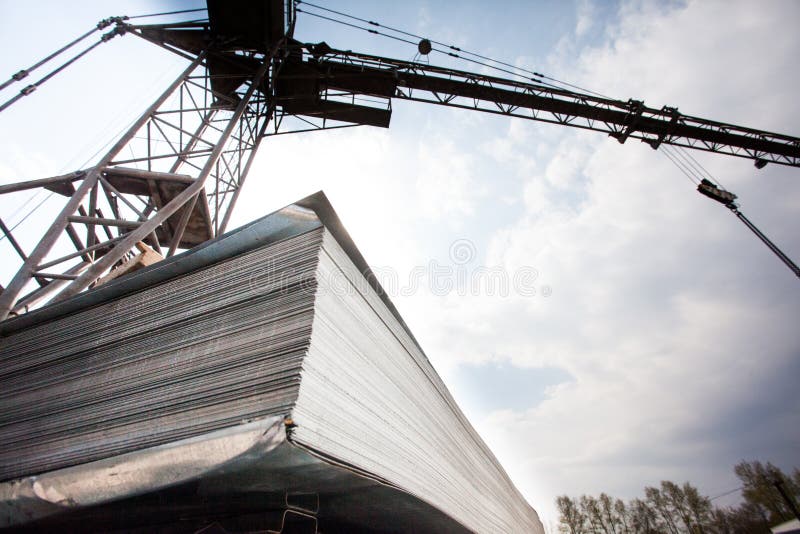 Crane and Stack of Steel Plates Stock Image - Image of metallic ...