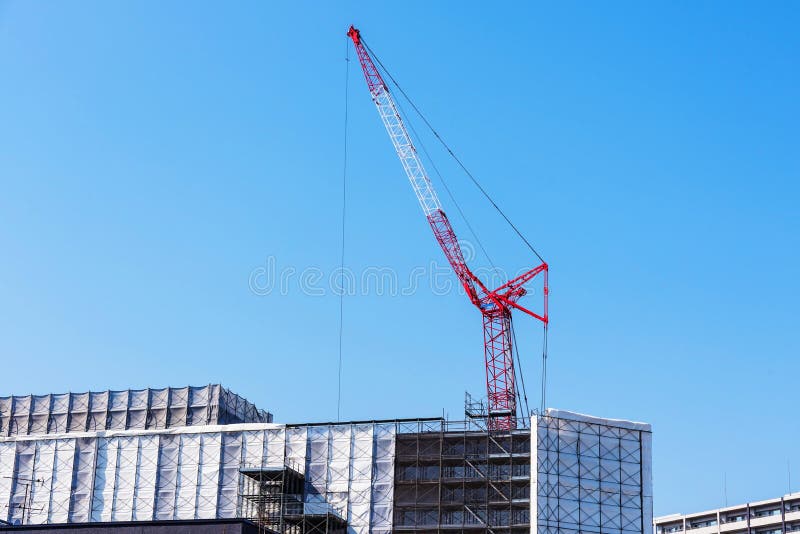 Crane on Top of Construction Building Stock Photo - Image of machinery ...