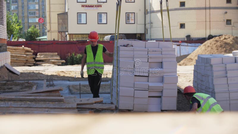 Crane Unloading Stone Panels for Pavement at Construction Site Stock ...