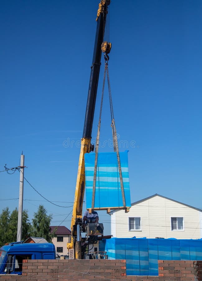 Crane Unloads Bricks at a House Construction Stock Photo - Image of ... Crane Unloads Bricks at a House Construction Stock Photo - Image of ...