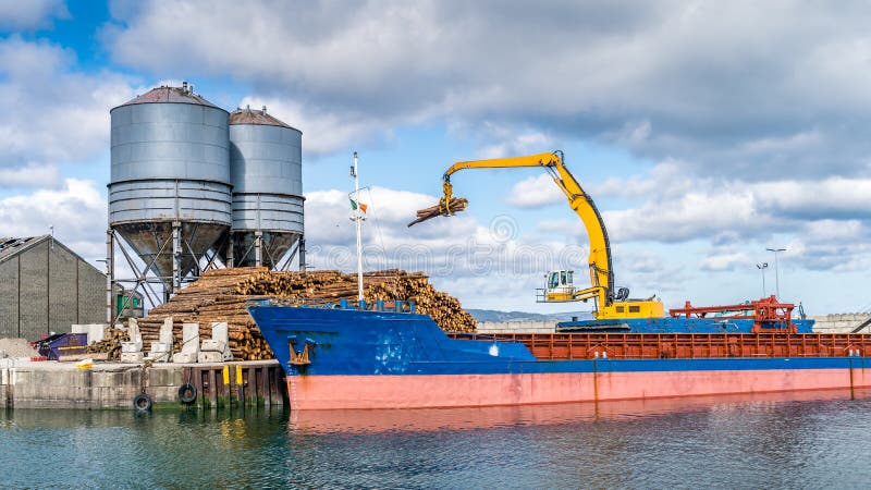 Crane with Wood Logs Gripple Loading Timber on Cargo Ship Stock Image ...