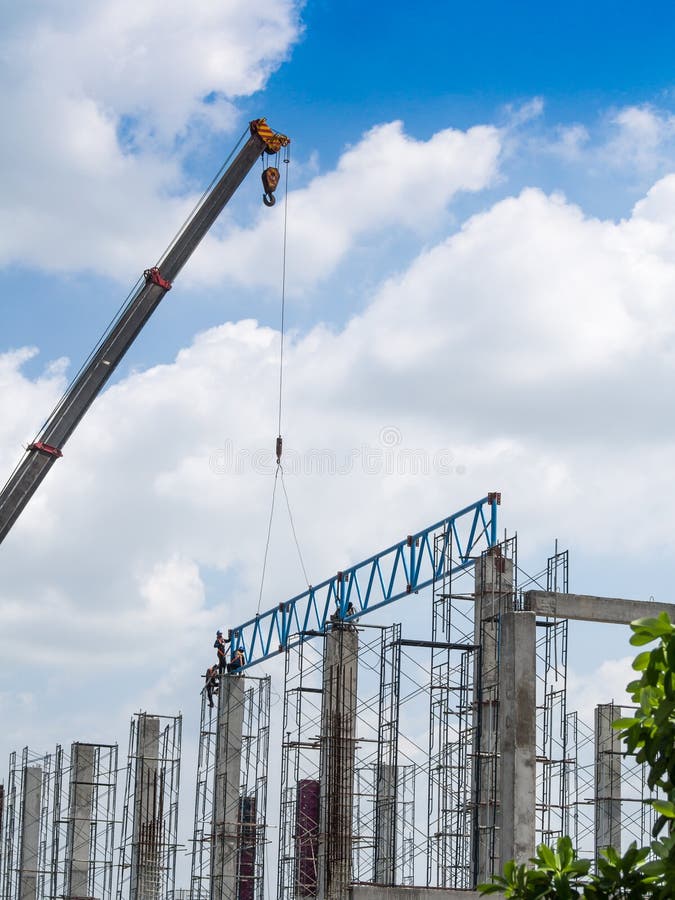 Crane and Workers at Construction Site and Blue Sk Stock Image - Image ...