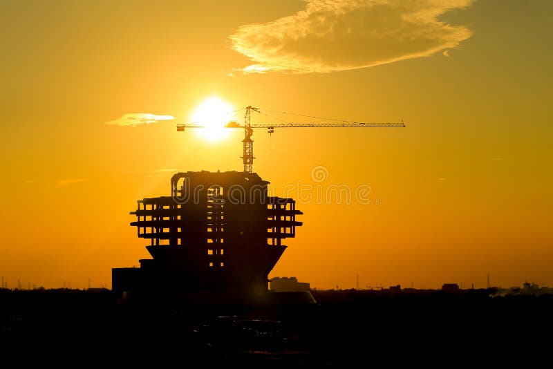 Cranes and Buildings Under Construction Against the Setting Sun Stock ...