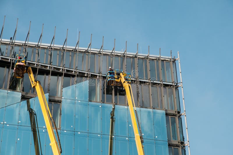 Cranes on Glass Facade Office Building Under Construction Stock Photo ...