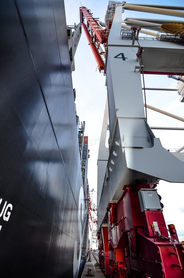 Cranes for Handling Containers on the Docks Next To a Container Ship ...